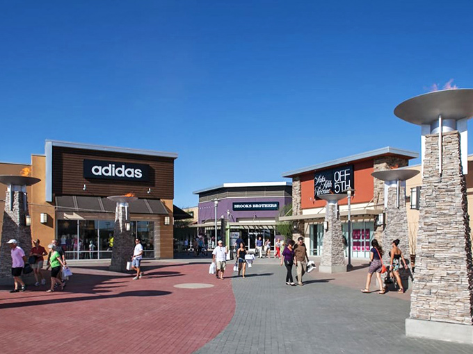 The architectural equivalent of a bargain hunter's dream&mdash;Phoenix Premium Outlets stands like a retail oasis against Arizona's blue sky, promising treasures within.