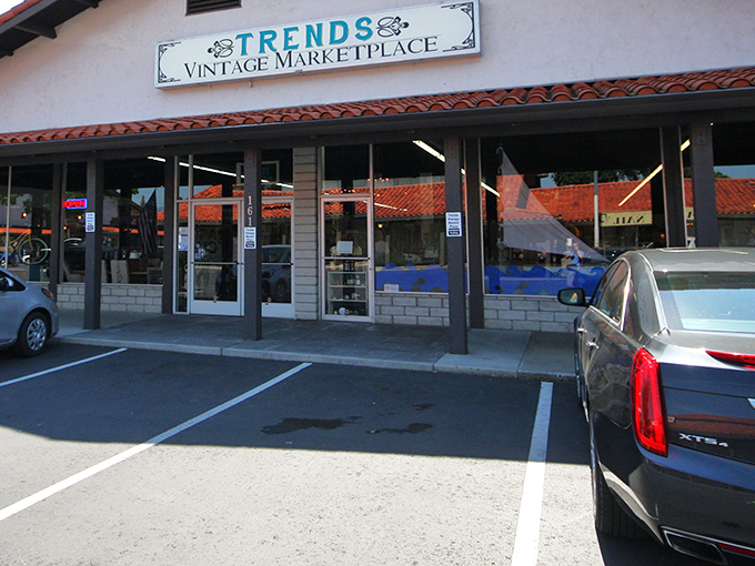 The unassuming exterior of Trends Vintage Marketplace belies the wonderland of treasures waiting inside. Spanish roof tiles and simple signage create vintage charm before you even enter.