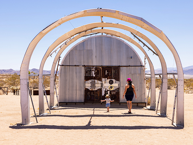 Desert alchemy at its finest! Bicycle wheels and metal barrels transform into a surreal caravan that seems ready to roll across the Mojave at any moment.
