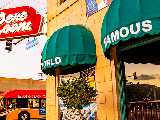 The tan facade with those iconic green awnings spelling "WORLD FAMOUS RENO ROOM" is like a beacon for thirsty travelers on East Broadway.