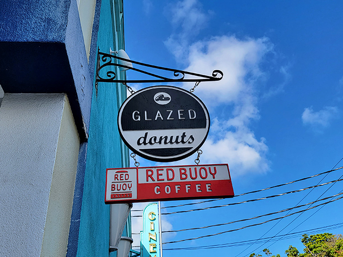 The iconic black and white Glazed Donuts sign beckons sweetly against Key West's blue sky, promising delicious treasures within.