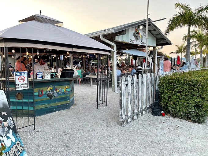 The Ugly Grouper's weathered wooden exterior and pastel-colored sign perfectly capture Florida's laid-back beach culture where flip-flops qualify as formal footwear.