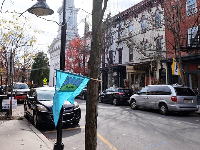 Bridge Street buzzes with small-town charm while the colorful "Lambertville" banner welcomes visitors to this riverside gem.