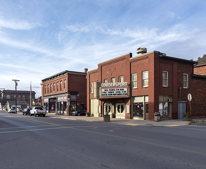 Main Street Coudersport in autumn glory &ndash; where brick buildings stand like sentinels against a backdrop of hills ablaze with fall foliage. Small-town America at its most photogenic. 