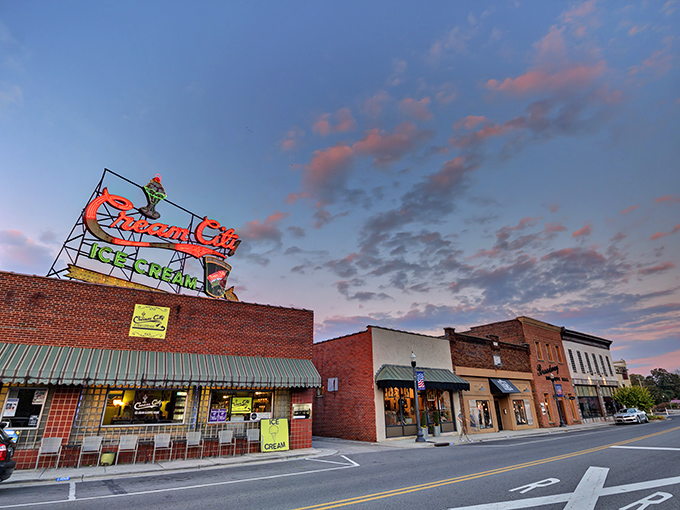 The iconic Cream City Ice Cream sign glows against the twilight sky, a beacon of sweetness that's been drawing locals and visitors alike for generations.