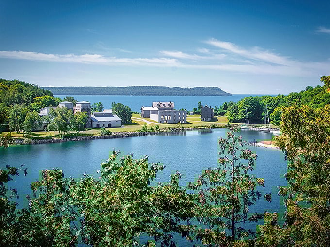 The imposing limestone blast furnaces stand like ancient temples against the azure waters of Snail Shell Harbor, a perfect marriage of industrial history and natural beauty.