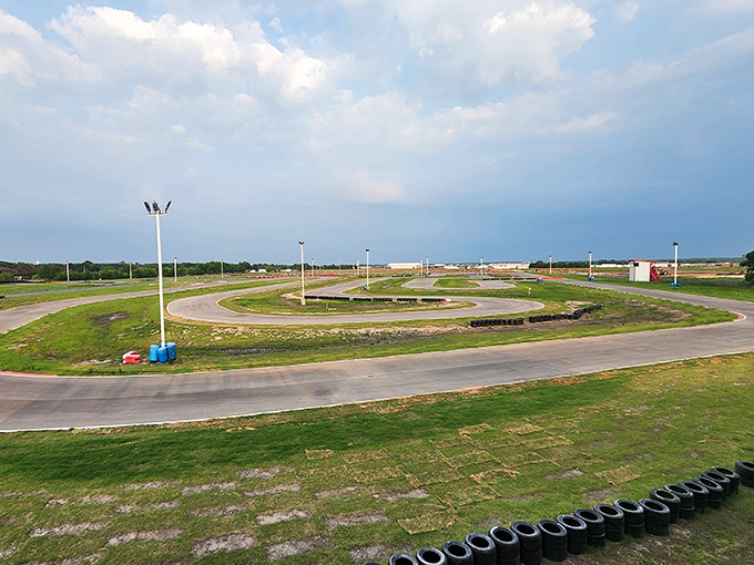 The half-mile track winds like a ribbon of asphalt promises, each curve secretly plotting against your ability to maintain dignity at high speeds.