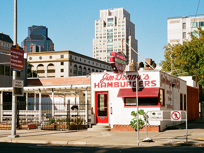 The iconic red sign beckons like a neon time machine, promising hamburgers and chili that have satisfied Sacramento appetites for generations.