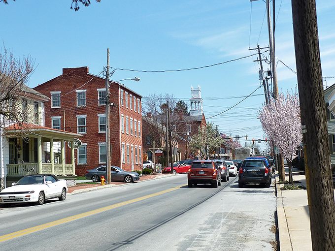 Main Street Strasburg offers that perfect small-town tableau where brick buildings stand like sentinels of simpler times, complete with flowering trees that know exactly when to bloom for tourists.