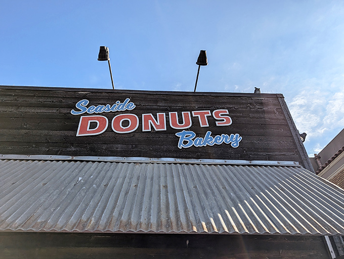 Palm trees stand sentry outside Seaside Donuts' wooden facade, nature's exclamation points announcing: "Something delicious happens here!"