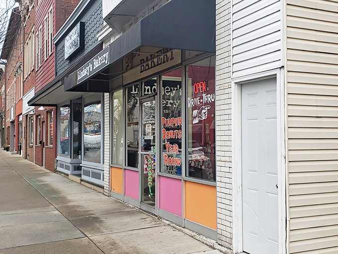 The unassuming storefront of Lindsey's Bakery beckons with its vintage charm and colorful panels. Donut paradise awaits behind that glass door.