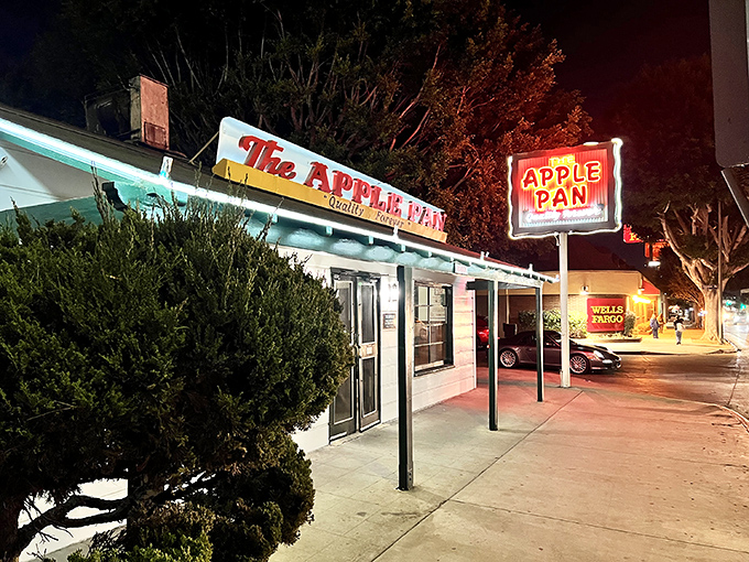 The unassuming white exterior of The Apple Pan stands like a time capsule on West Pico Boulevard, its vintage sign promising "Quality Forever" &ndash; a bold claim it's managed to fulfill for decades.