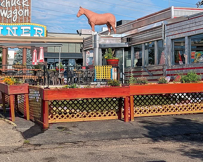 The gleaming chrome exterior of Davies' Chuck Wagon Diner shines like a time machine to the 1950s, complete with those classic horizontal stripes that scream "American optimism."