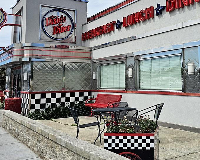 The gleaming chrome exterior of Dixie's Diner shines like a beacon of hope for hungry travelers, its classic checkerboard trim promising authentic American comfort food inside.