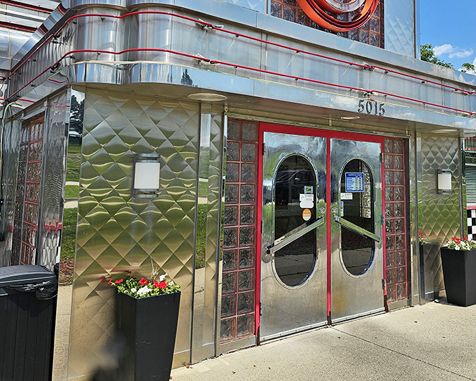 The gleaming stainless steel exterior with classic checkered trim promises a time-traveling culinary adventure before you even step inside.