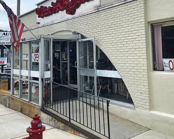 The neon glow of Victor's 50's Diner sign beckons like a time machine disguised as a restaurant. Hudson's retro gem promises comfort food that'll make your cardiologist wince and your soul sing.