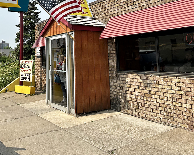 A humble brick fortress with an American flag standing guard, protecting the culinary treasures that await inside.