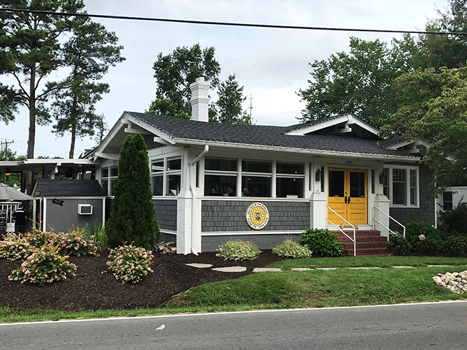 Those sunny yellow doors aren't just welcoming you to breakfast&mdash;they're practically daring you not to smile. Cottage charm with a side of morning promise.