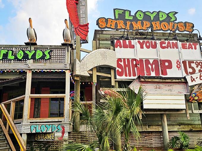 Floyd's neon sign blazes against the twilight sky like a lighthouse for hungry sailors, complete with pelican sentinels standing guard over shrimp paradise.