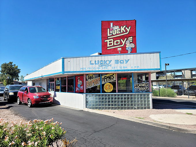 The iconic red and white Lucky Boy sign stands like a beacon of burger hope against the Arizona sky. Simplicity never looked so inviting.