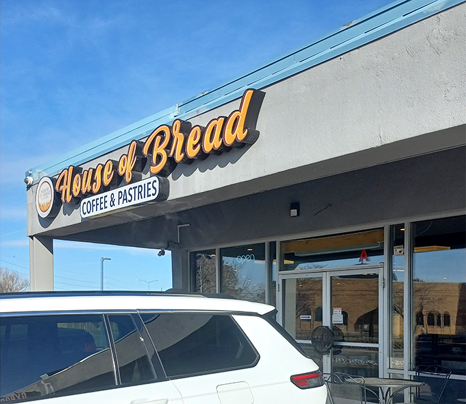 The blue-roofed sanctuary of carbs announces itself with golden lettering that practically whispers, "Yes, this is where the good stuff lives."