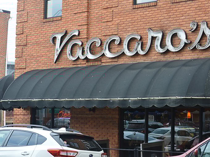 The corner brick building stands like a sentry guarding Little Italy's sweetest treasures, its black awnings a beacon for dessert pilgrims.