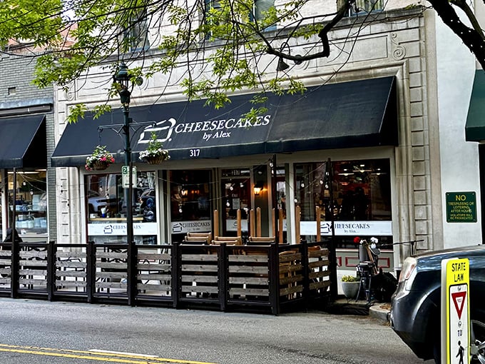 The navy blue awning of Cheesecakes by Alex beckons like a dessert lighthouse on Greensboro's Elm Street, promising sweet salvation for the sugar-deprived.