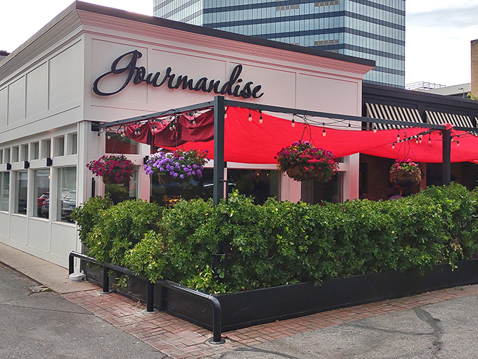 Gourmandise's charming exterior with vibrant red awnings and hanging flower baskets creates an instant European escape in downtown Salt Lake City.