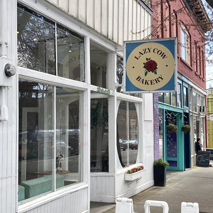 The unassuming white exterior of Lazy Cow Bakery proves once again that Seattle's best culinary treasures often hide in plain sight, no neon required.