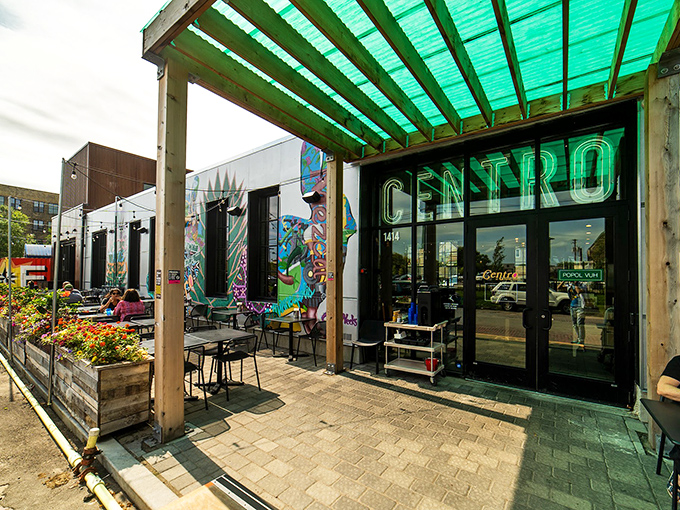 Centro's neon sign glows like a turquoise beacon against the twilight sky, promising Mexican delights in Northeast Minneapolis's urban landscape.