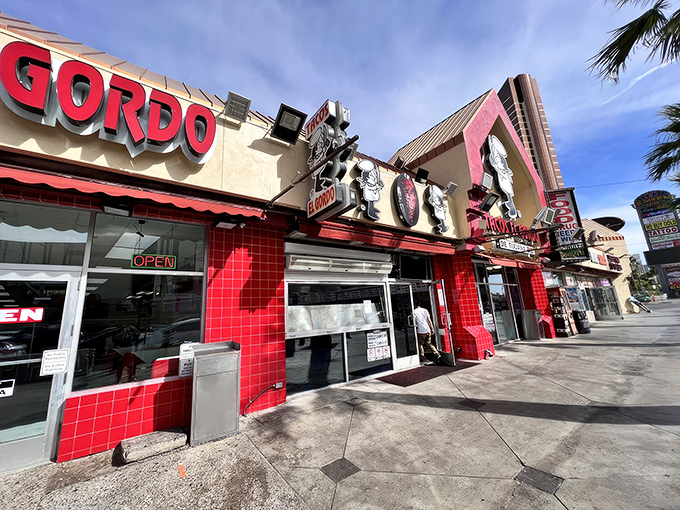 The vibrant red exterior of Tacos El Gordo stands out like a beacon of hope for hungry souls wandering the Las Vegas desert.
