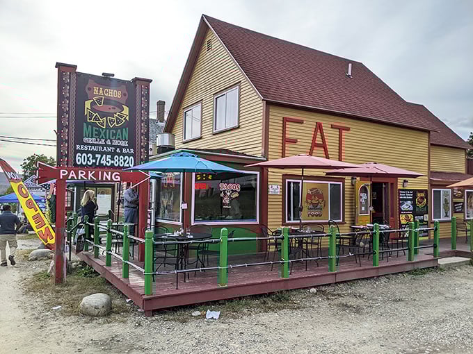 The yellow and red exterior of Nachos Mexican Bar and Grill stands out like a sombrero at a ski lodge, beckoning hungry travelers with its vibrant charm.