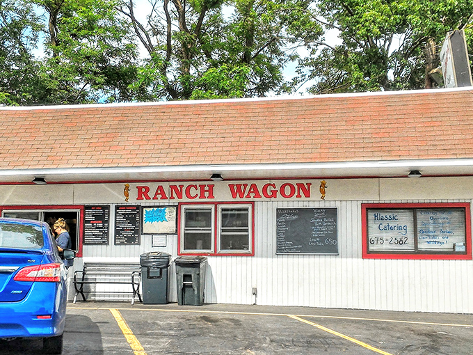 The unassuming white exterior with bold red lettering promises no frills, just thrills for your taste buds. Roadside perfection awaits.