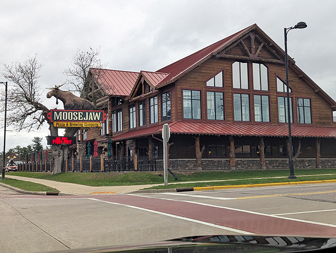 The log cabin palace of pizza rises from the Wisconsin landscape like Paul Bunyan's dream retirement home, complete with a watchful moose guardian.