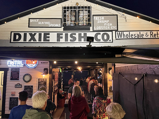 Old Florida charm meets seafood paradise. Palm trees stand guard outside Dixie Fish Company, where the "Wholesale & Retail" sign hints at seriously fresh catches.