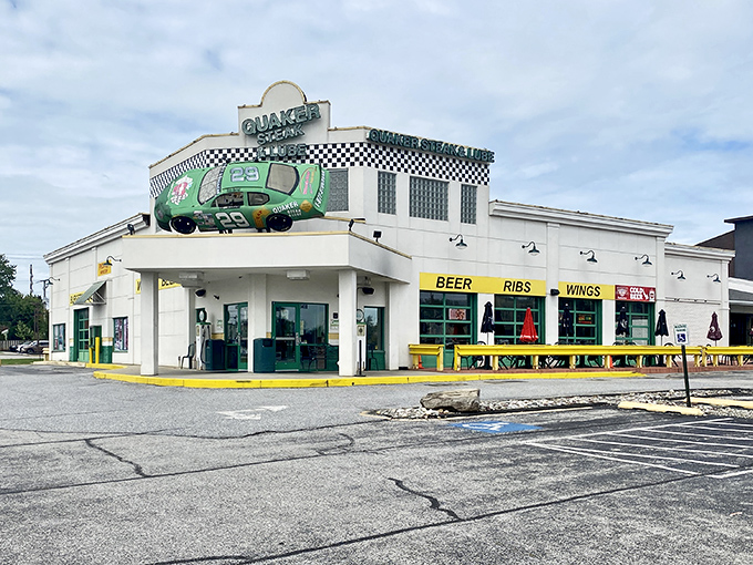 The ultimate pit stop for hungry travelers! Quaker Steak & Lube's iconic exterior features a green NASCAR-style race car that's permanently parked on the roof.