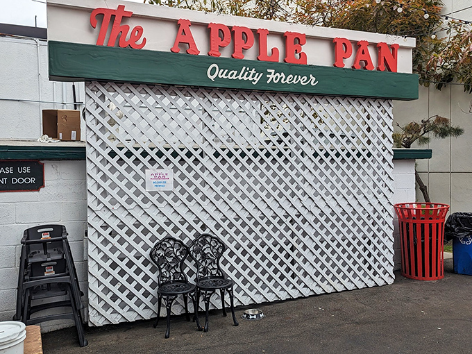 The unassuming white exterior of The Apple Pan stands like a time capsule on West Pico Boulevard, its vintage sign promising "Quality Forever" &ndash; a bold claim it's managed to fulfill for decades.