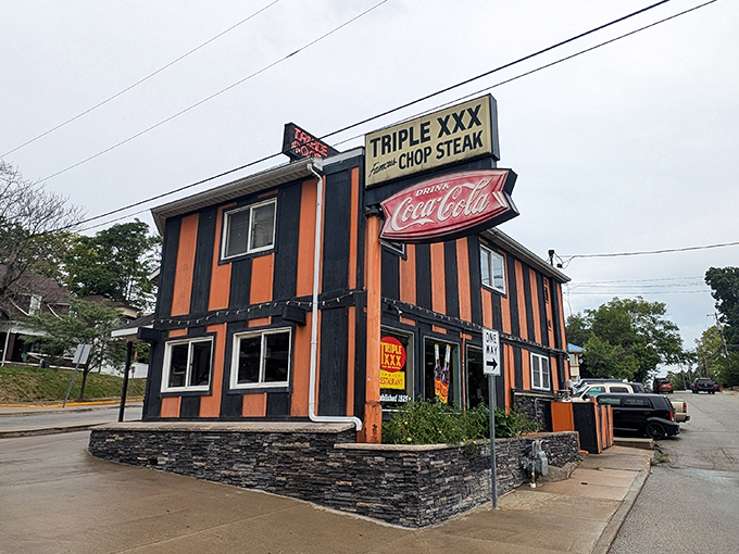 The unmistakable orange and black stripes of Triple XXX stand as a beacon to hungry travelers, promising nostalgic flavors and Hoosier hospitality at Indiana's oldest drive-in.