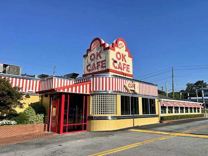 The iconic red and white striped awning of OK Cafe stands out against the Atlanta sky like a beacon for hungry souls seeking Southern comfort.