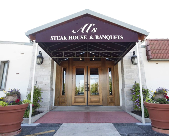 The entrance to Al's Steak House promises what lies beyond those wooden doors – a carnivore's paradise where memories are made one slice at a time.