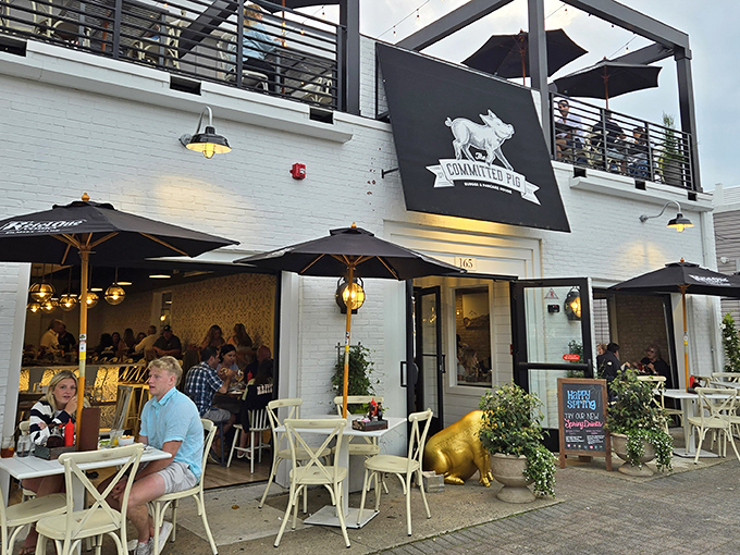 The Committed Pig's charming white exterior with rooftop dining is like finding the VIP section of Jersey Shore dining—complete with American flag and umbrellas for those who prefer shade with their indulgence.