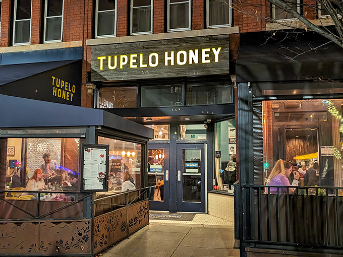The golden-lettered storefront beckons like a Southern siren song, promising comfort food salvation on a busy Asheville street.