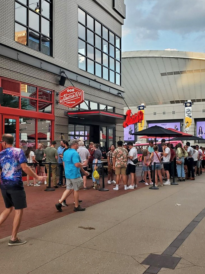 The iconic red glow of Hattie B's beckons hungry pilgrims like a Nashville neon lighthouse. Even at dusk, the line forms for that crispy, spicy salvation. 