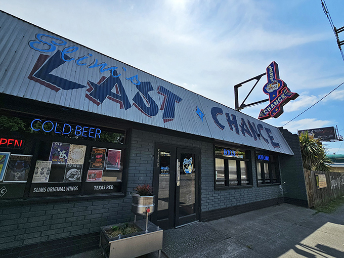The neon-lit promise of "Slim's Last Chance" beckons like a honky-tonk mirage in Seattle's industrial landscape. Cold beer awaits inside this unassuming chili paradise.