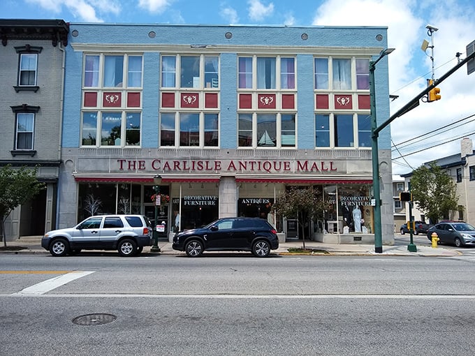 The striking blue fa&ccedil;ade of The Carlisle Antique Mall stands as a beacon for treasure hunters on Hanover Street, promising adventures in every window.