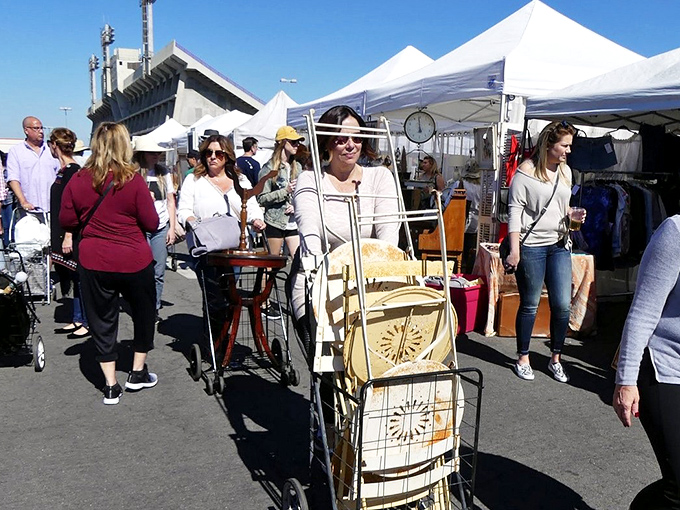 Treasure hunters navigate the sea of white tents, carts at the ready. The thrill of the hunt is palpable under the California sun.