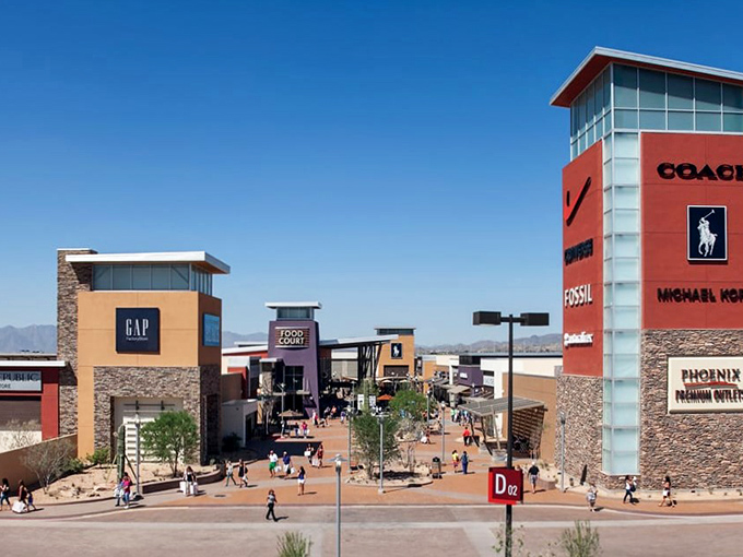 The architectural equivalent of a bargain hunter's dream&mdash;Phoenix Premium Outlets stands like a retail oasis against Arizona's blue sky, promising treasures within.
