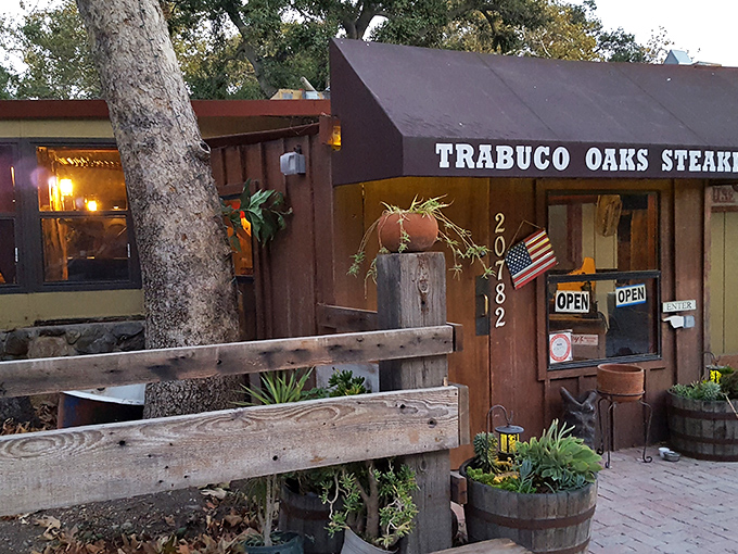 This rustic steakhouse exterior whispers "authentic" louder than a dinner bell at suppertime.