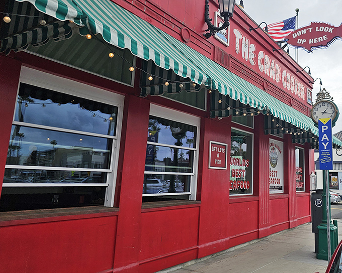 The bright red exterior of The Crab Cooker glows like a culinary lighthouse, beckoning seafood lovers to Newport Beach's most unpretentious treasure.