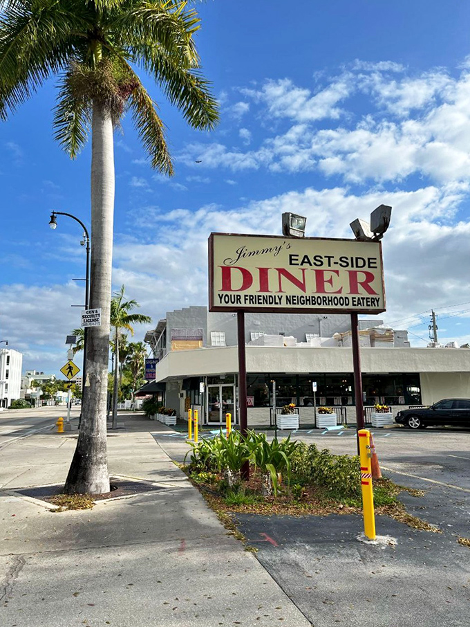 The iconic red and yellow exterior of Jimmy's Eastside Diner stands as a beacon of breakfast hope amid Miami's palm trees and sunshine.